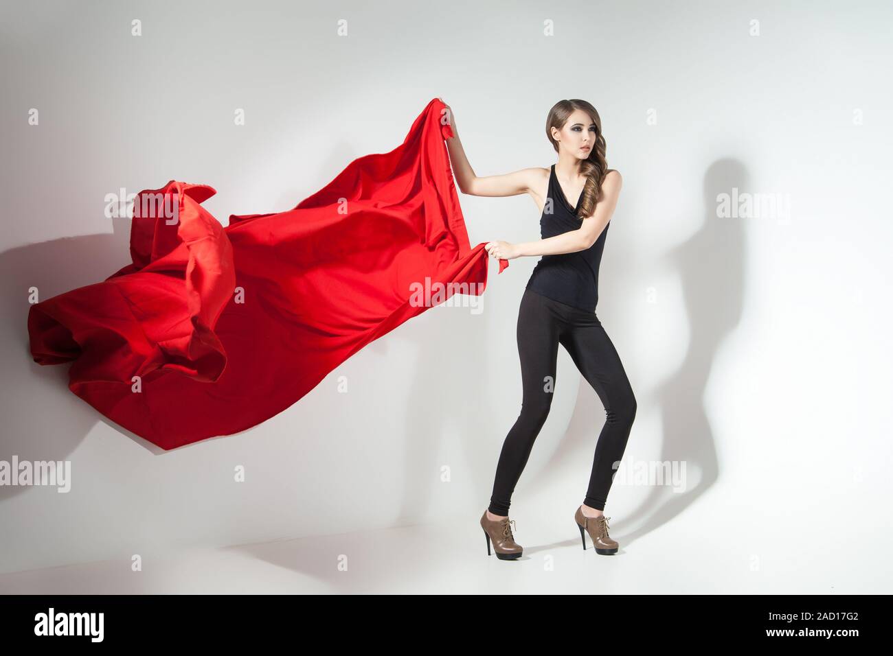 Girl holding red cloth waving Stock Photo - Alamy