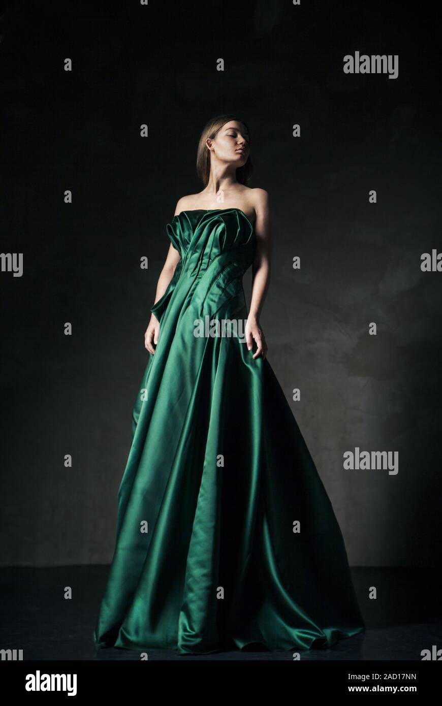 Model posing in green fashion dress Stock Photo - Alamy