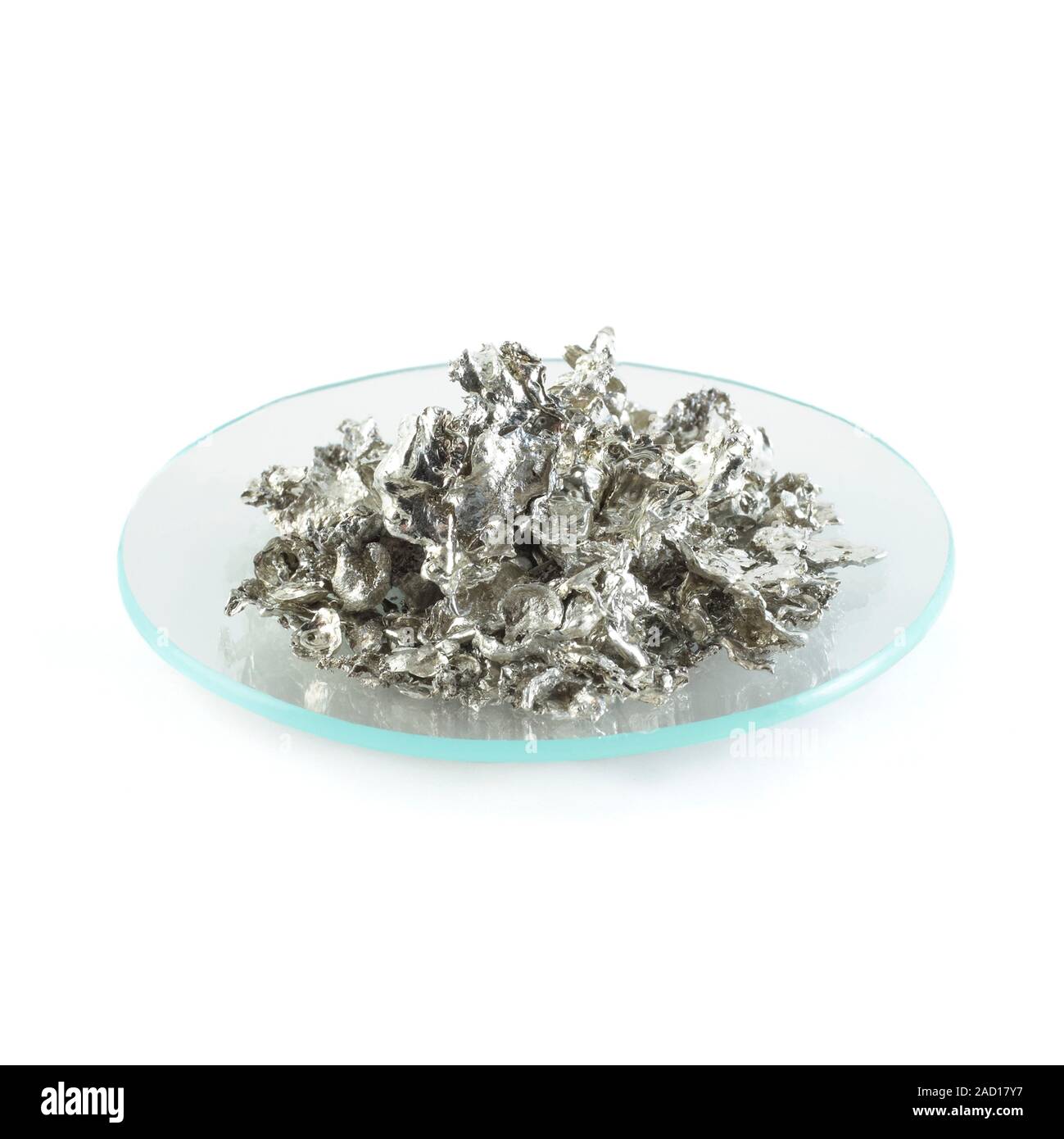 A pile of granules of tin. Tin is a post-transition main group metallic ...