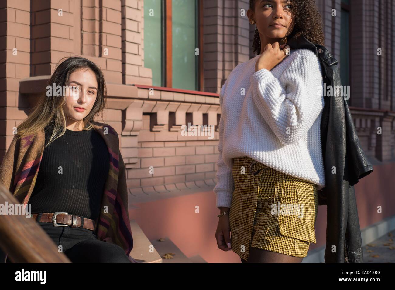 A pair of beautiful young fashionable Spanish girls, against the ...