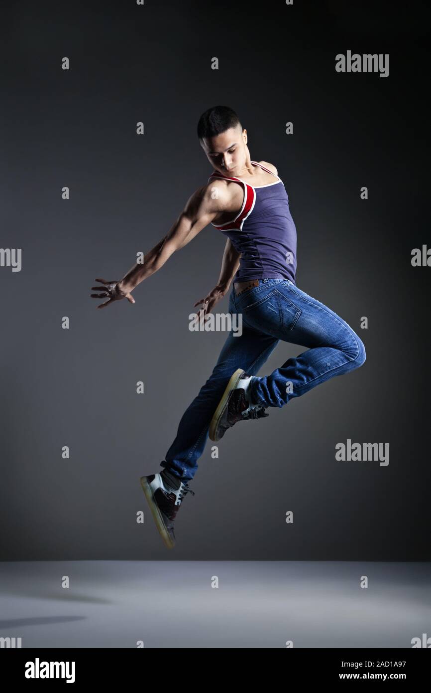 Dancer posing in front of the studio background Stock Photo - Alamy