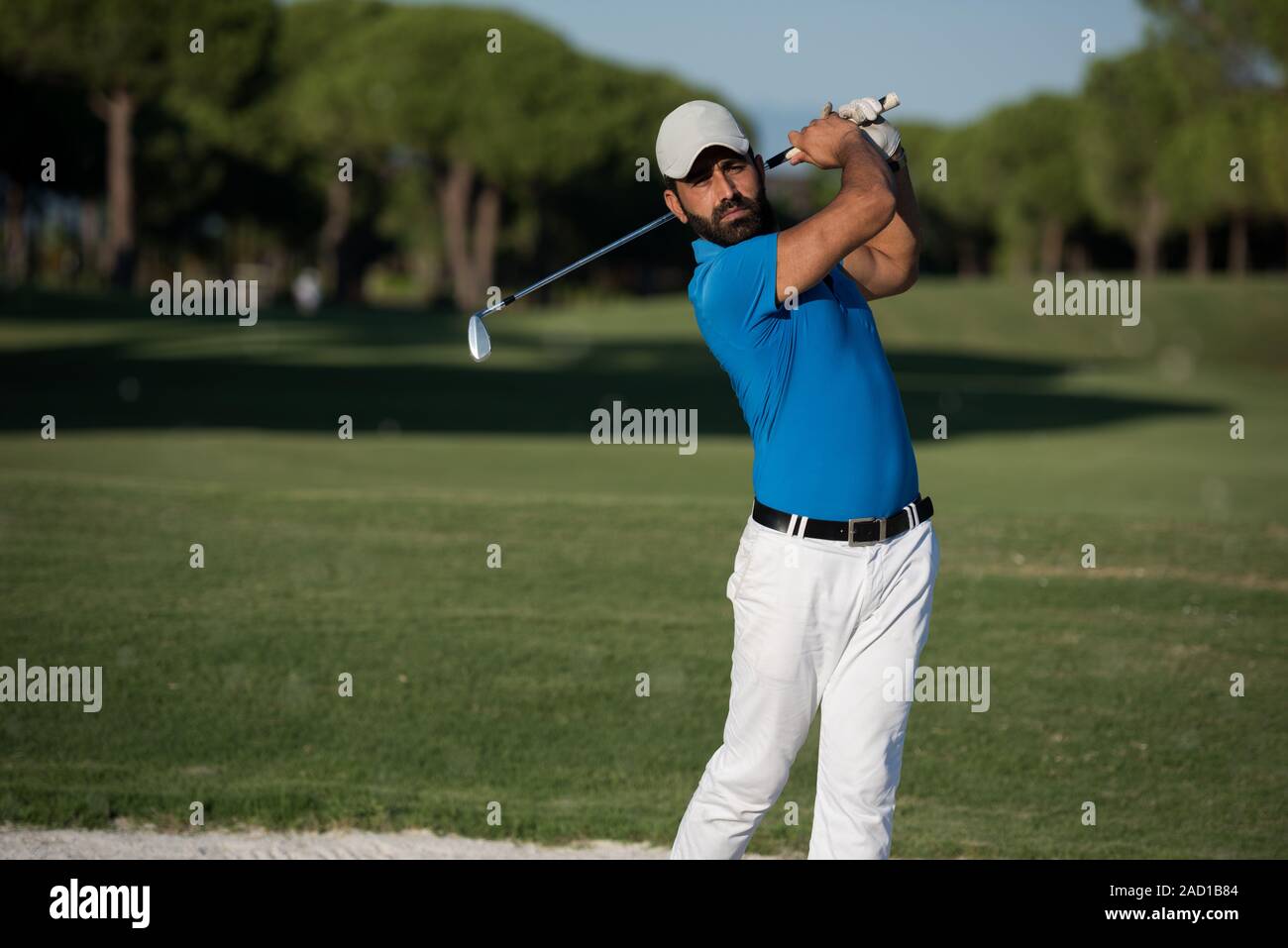 pro golfer hitting a sand bunker shot Stock Photo - Alamy