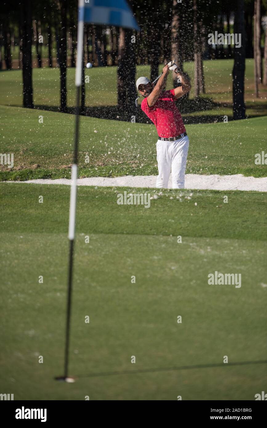golfer hitting a sand bunker shot Stock Photo - Alamy
