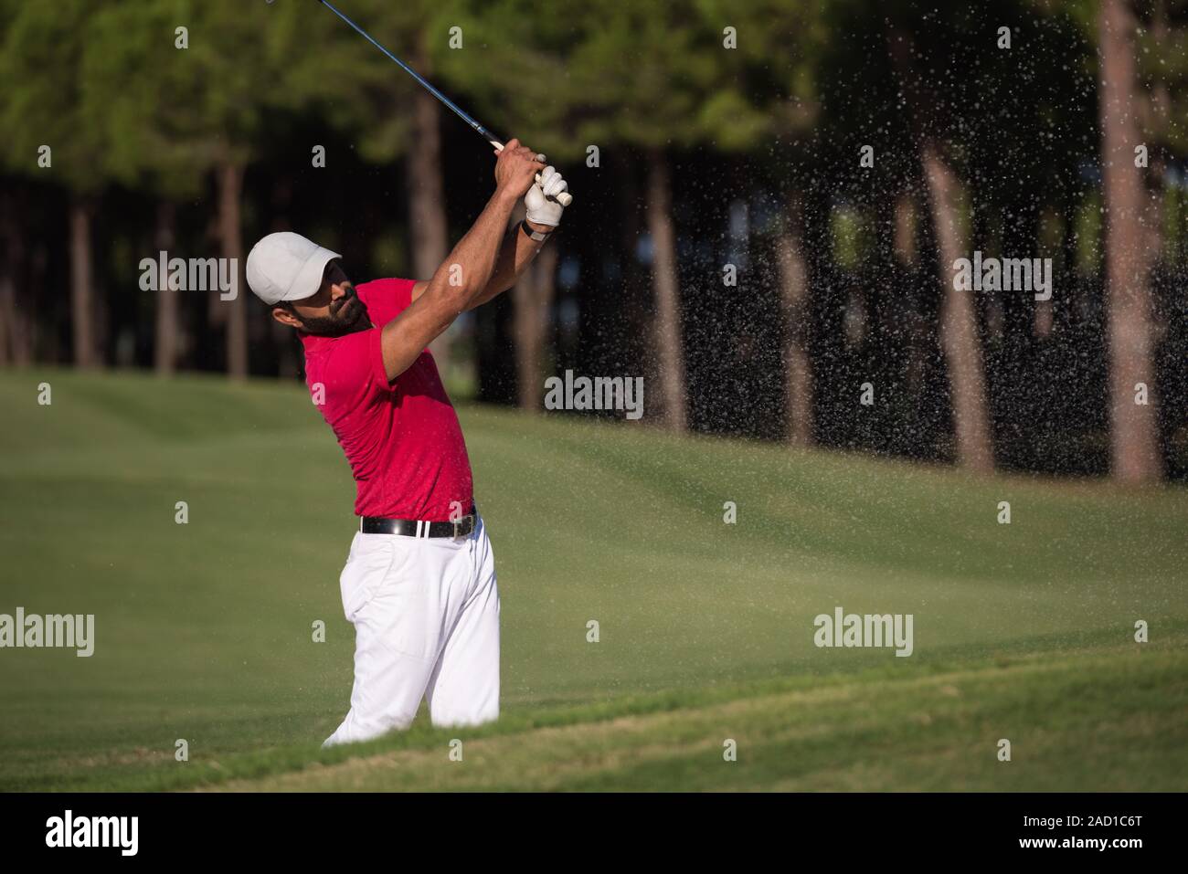golfer hitting a sand bunker shot Stock Photo - Alamy
