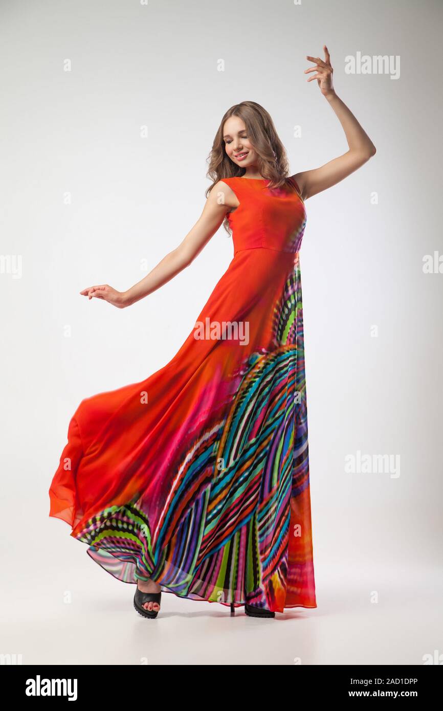 Beautiful woman in bright colorful dress dancing Stock Photo - Alamy