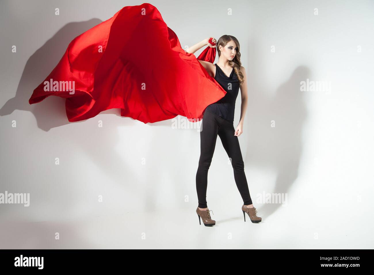 Girl holding red cloth waving Stock Photo - Alamy