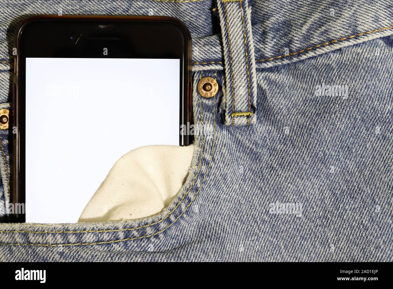 Mock up white screen phone peeping out of the pocket of light blue ...