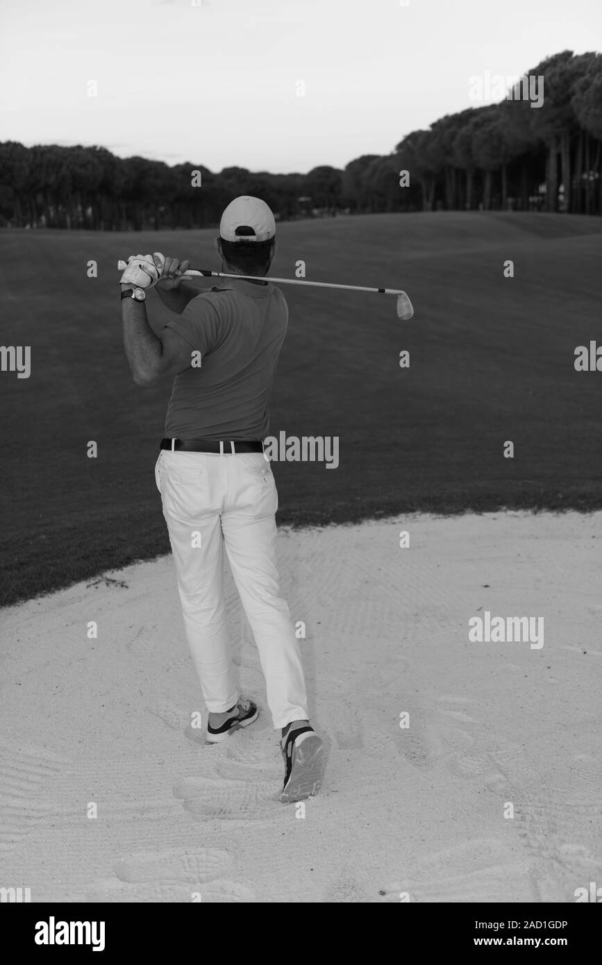 golfer hitting a sand bunker shot on sunset Stock Photo - Alamy