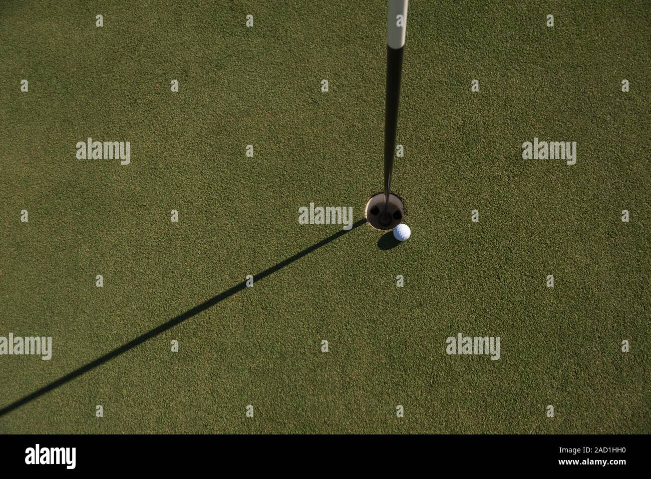 top view of golf ball in the hole Stock Photo - Alamy