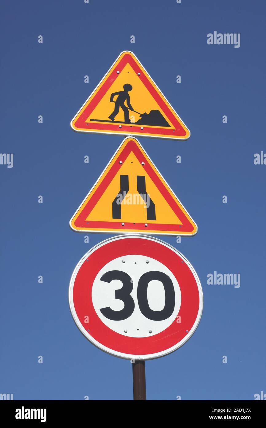 Road signs. Set of three road signs indicating (from top): road works ...