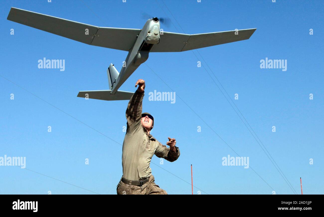 US military surveillance drone. US officer launching an AeroVironment ...