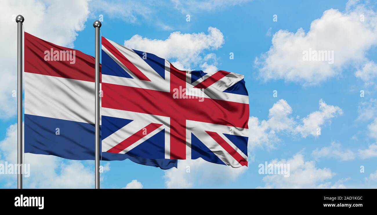 Netherlands and United Kingdom flag waving in the wind against white ...