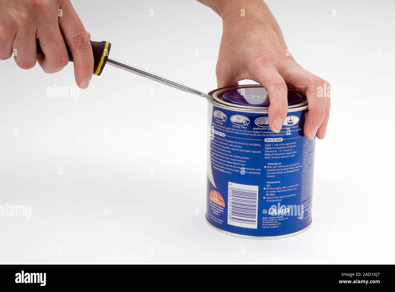 Opening a can with a lever. Person using a screwdriver as a lever to ...