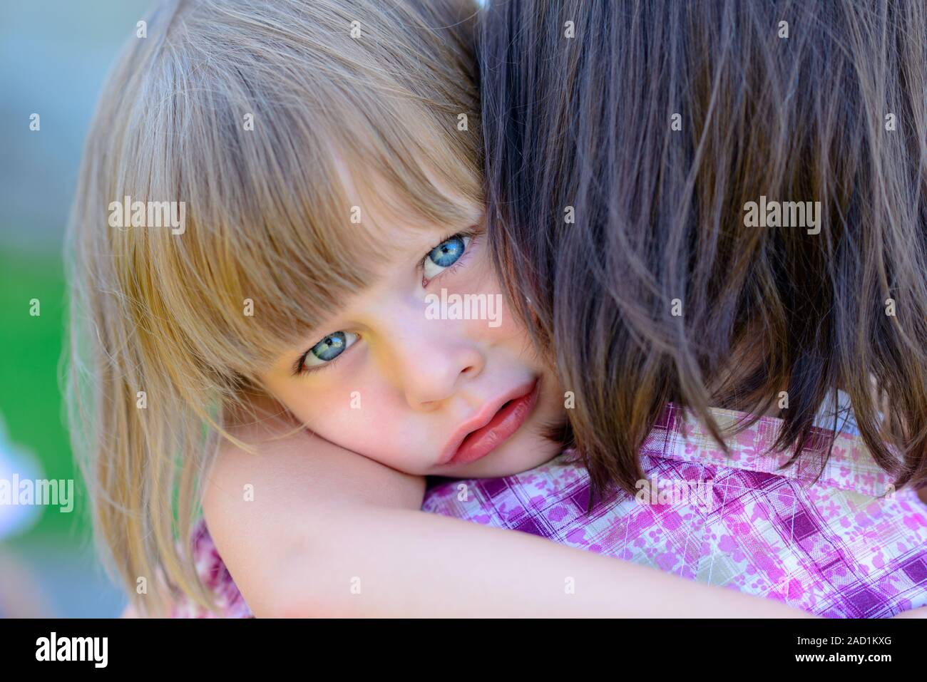sad little girl hugging her mother Stock Photo - Alamy