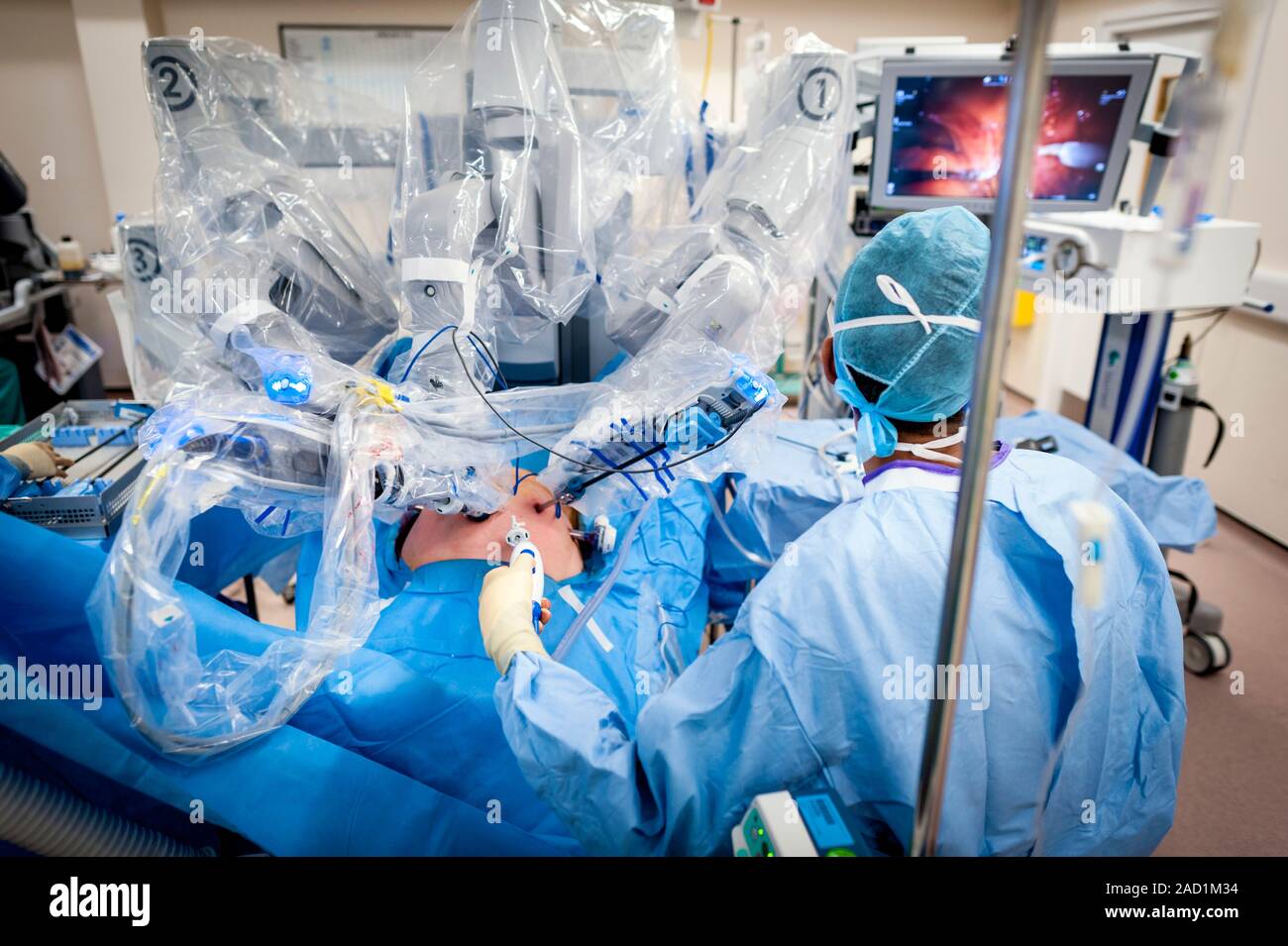 Robotic surgery. Da Vinci robot surgeon (upper centre) being used to ...