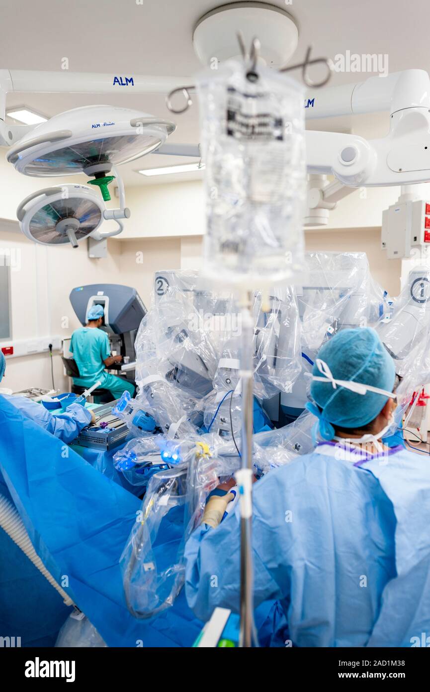 Robotic surgery. Da Vinci robot surgeon (centre) being used to remove a ...