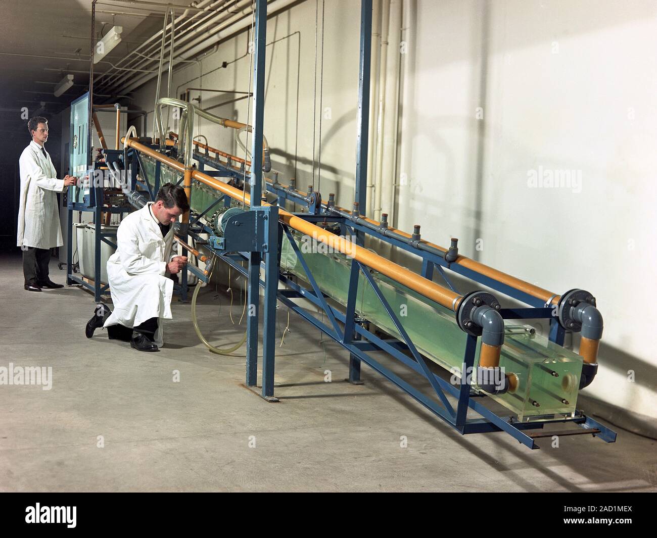 Fluid dynamics test apparatus. Researchers preparing an apparatus to be ...