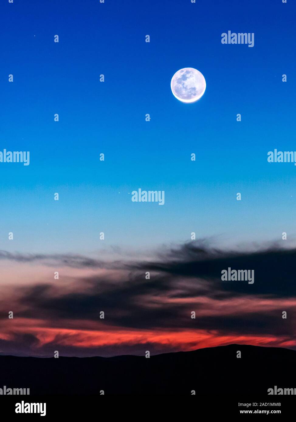 Full moon at dawn. Full moon and earthshine (sunlight reflected from ...