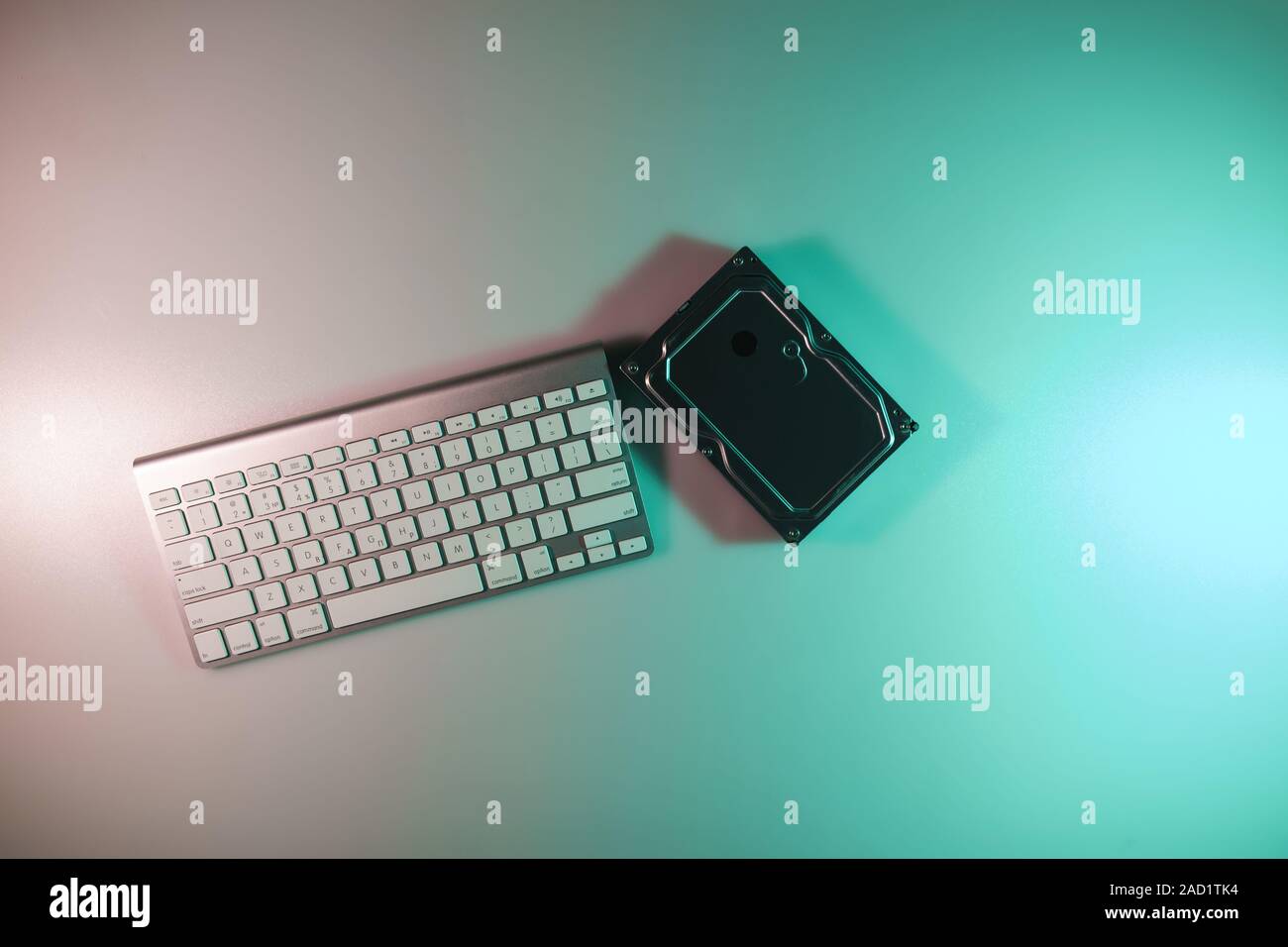 Beautiful modern silver keyboard in the color light on a table and ...