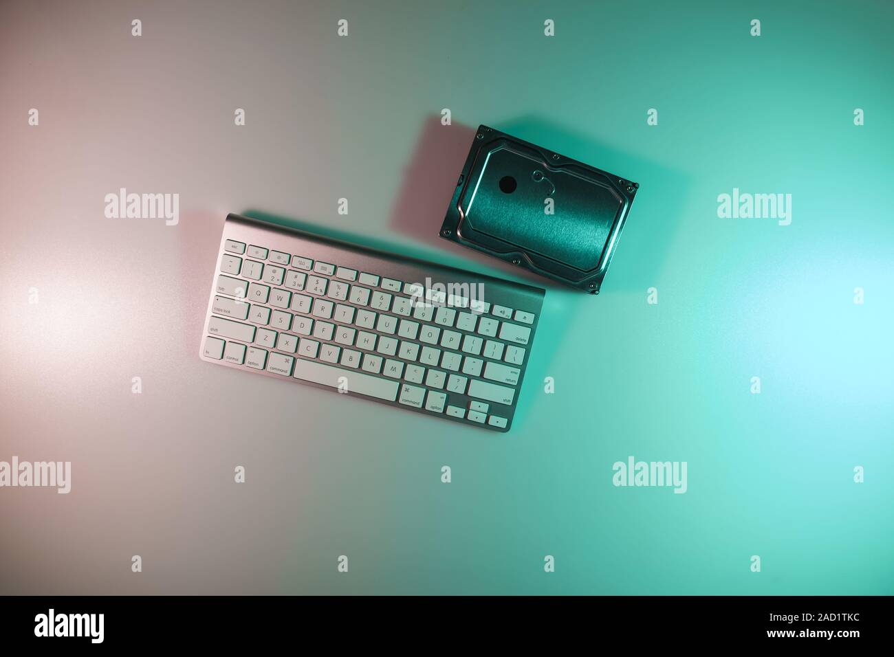 Beautiful modern silver keyboard and hard disk in the color light on a ...