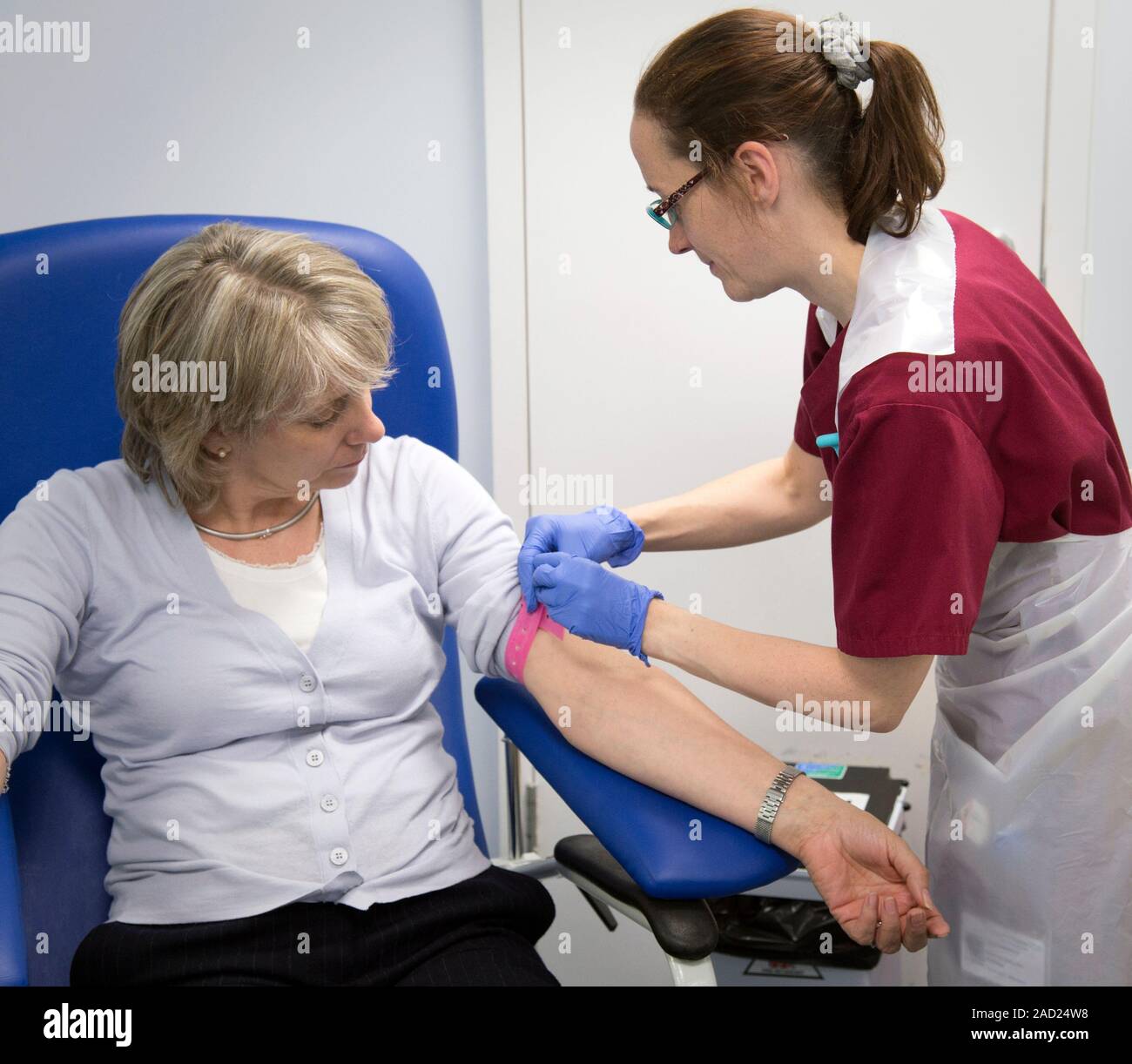 Hospital radiology patient and nurse. Patient being prepared by a nurse ...