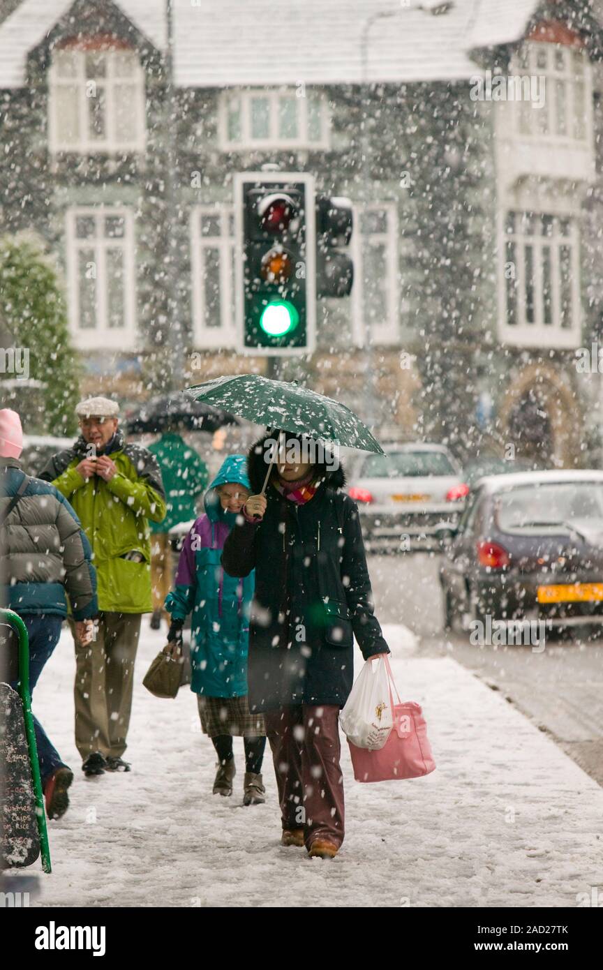 Shoppers trudging through snow in Ambleside, UK Stock Photo - Alamy