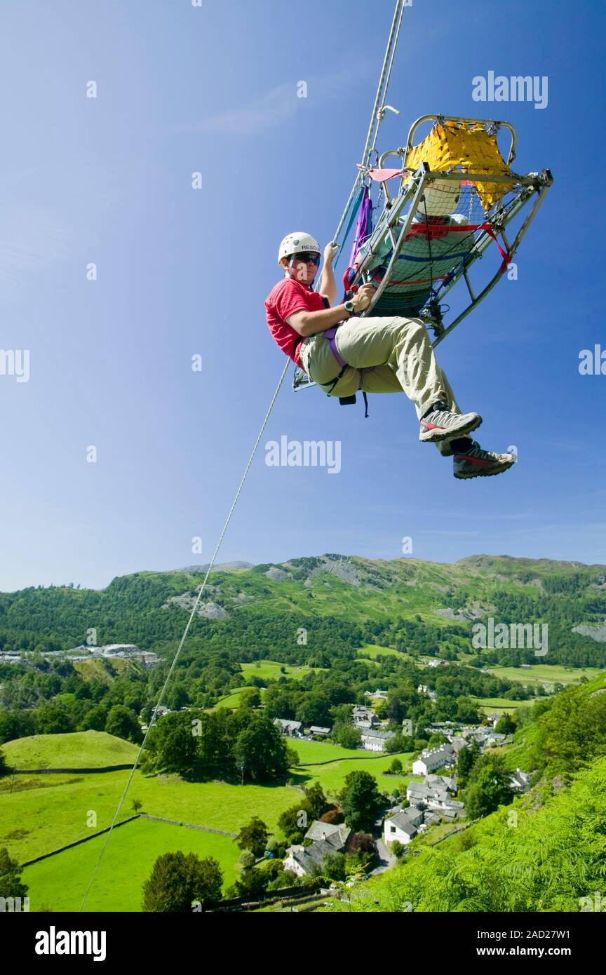 Members of Langdale Ambleside Mountain Rescue Team lowering a stretcher ...