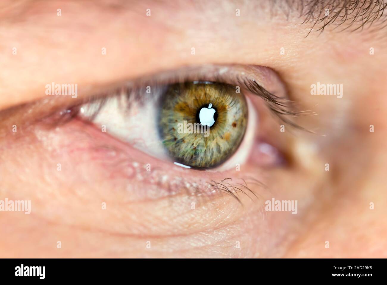 Eye and Apple logo. Conceptual image of a human eye with a reflection ...