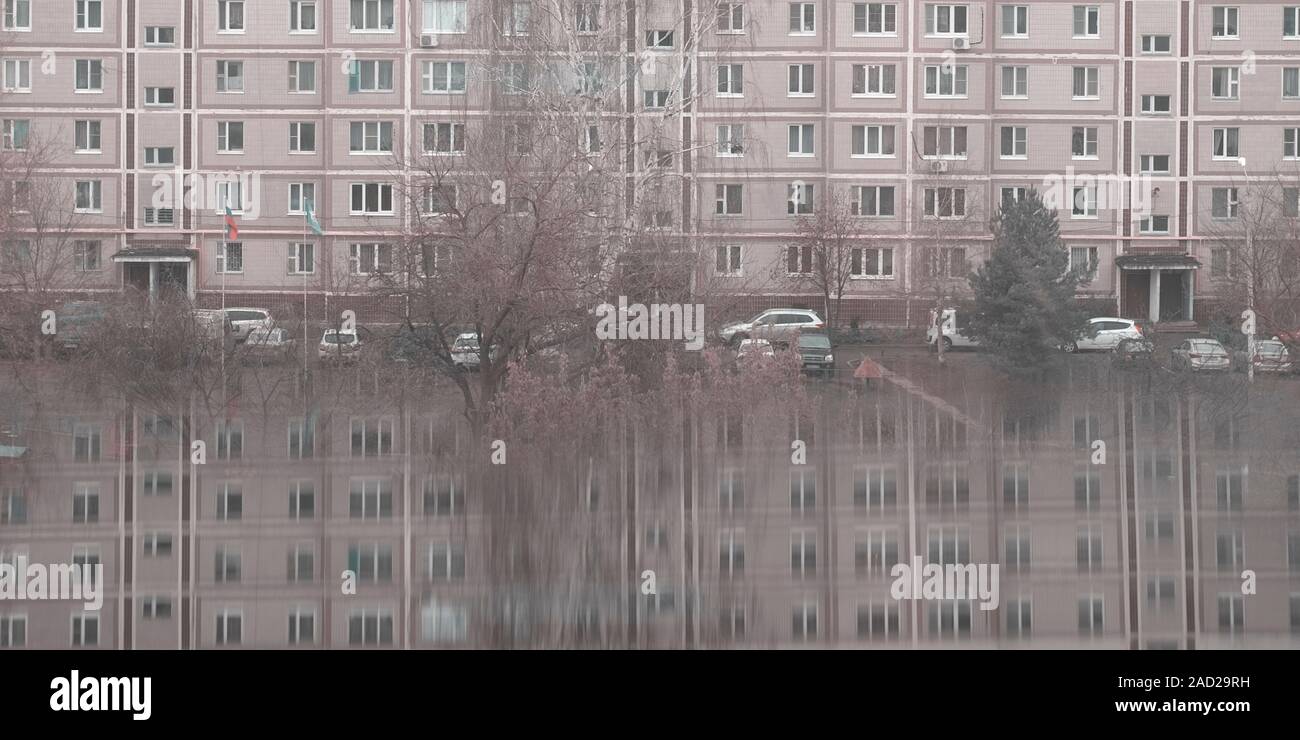 Many windows on apartment house in small town with reflection. Gray ...