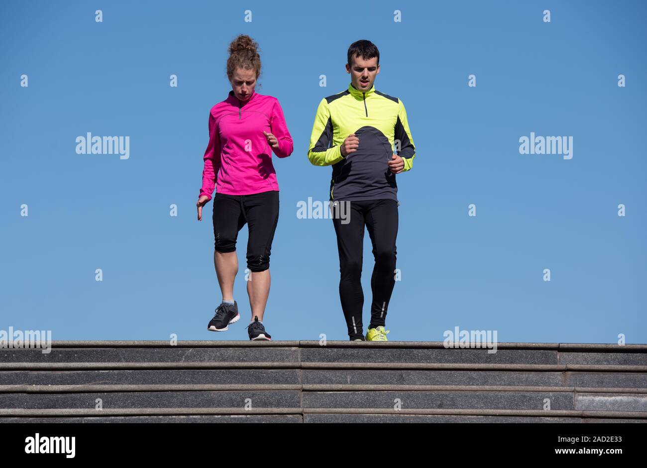 young couple jogging on steps Stock Photo - Alamy