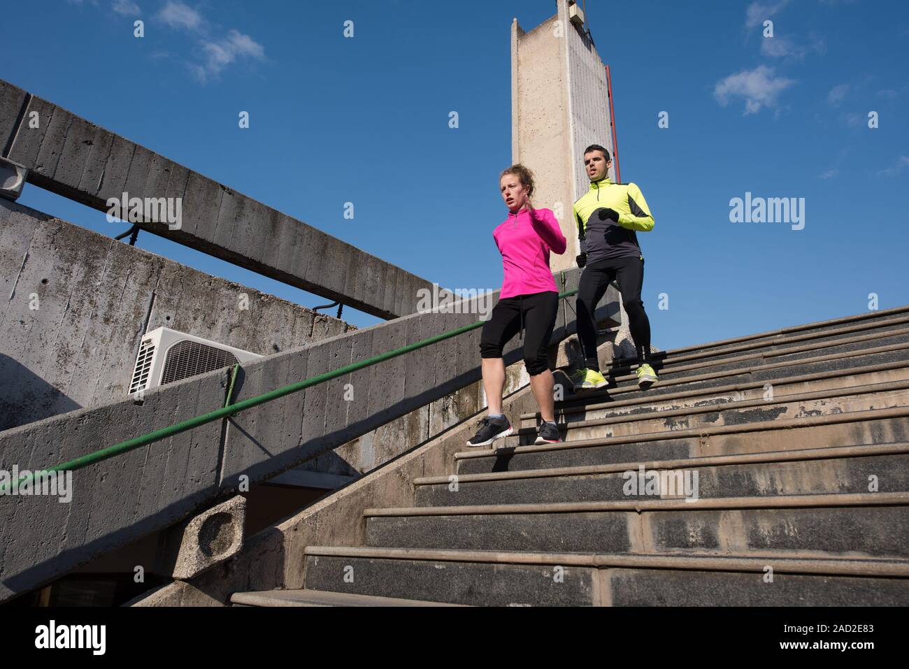 young couple jogging on steps Stock Photo - Alamy