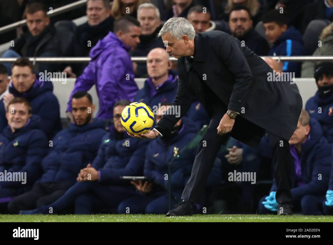 Manager of Tottenham Hotspur, Jose Mourinho cradles the ball ...