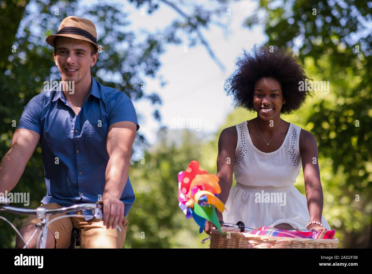 Young multiethnic couple having a bike ride in nature Stock Photo - Alamy