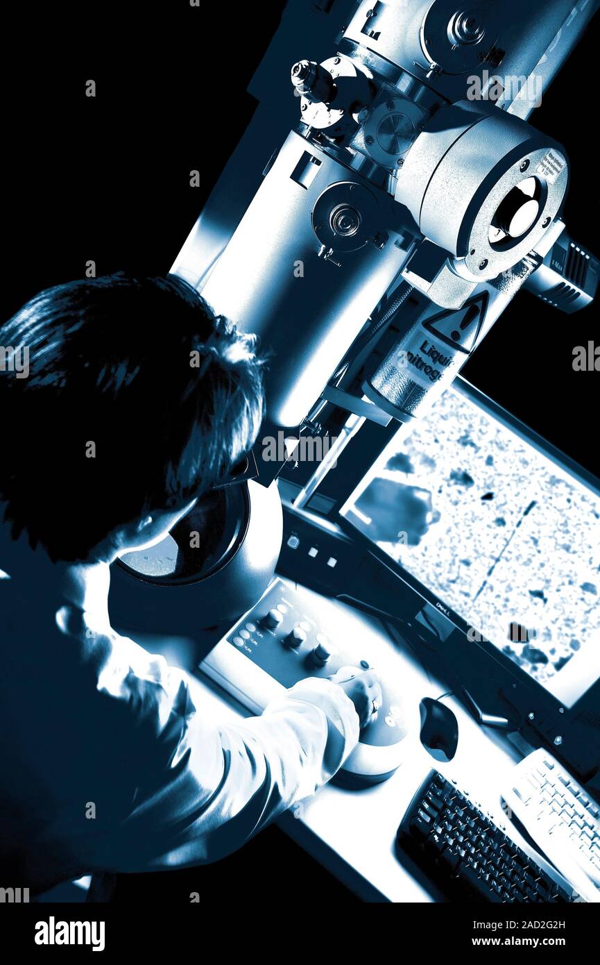 Transmission electron microscopy. Researcher operating a transmission ...