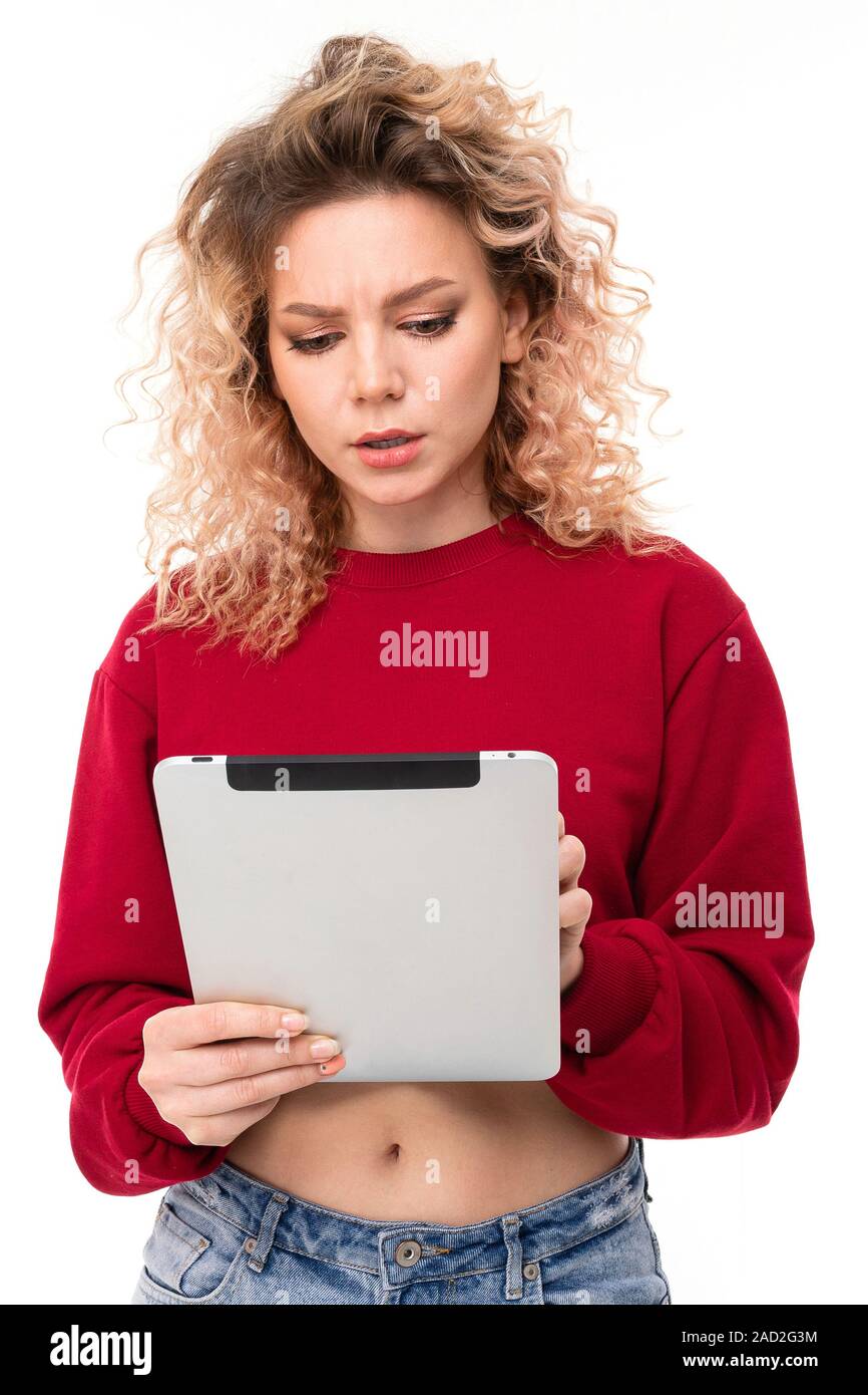 European girl reads messages on a tablet on a white background Stock ...