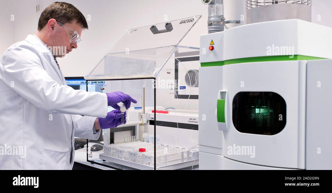 Atomic emission spectroscopy analysis. Researcher preparing samples for ...