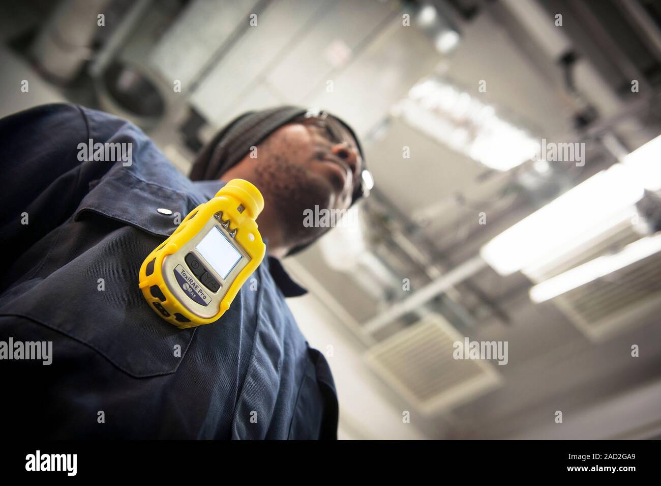 Portable gas detector. Industrial worker wearing a portable gas ...