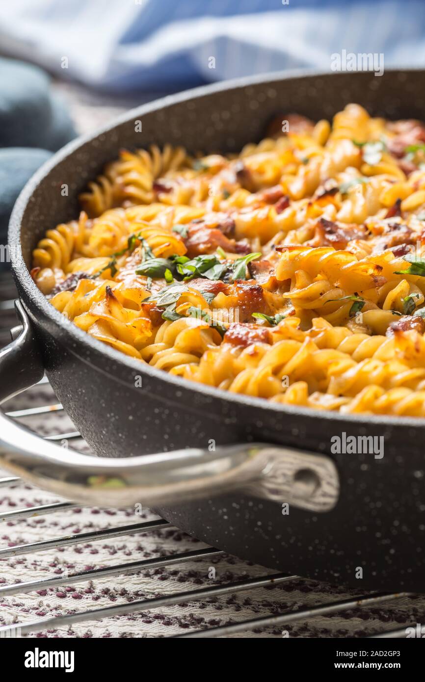 Baked pasta fusilli with smoked pork neck mozzarela cheese and othe ...