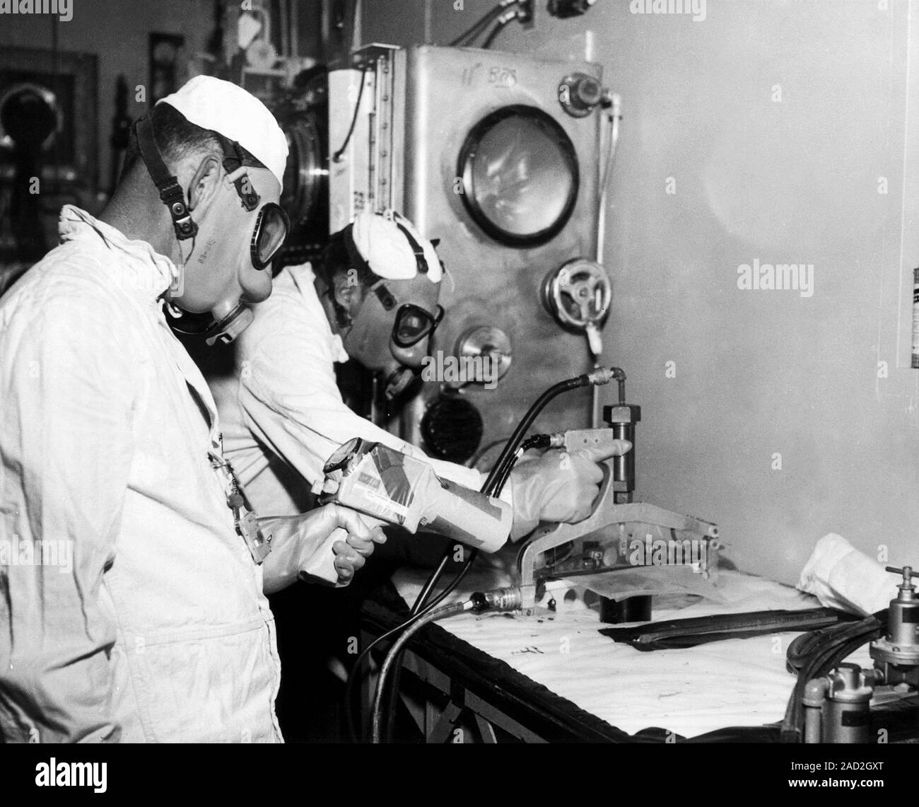 Scientists working with plutonium. Plutonium is a long-lived ...