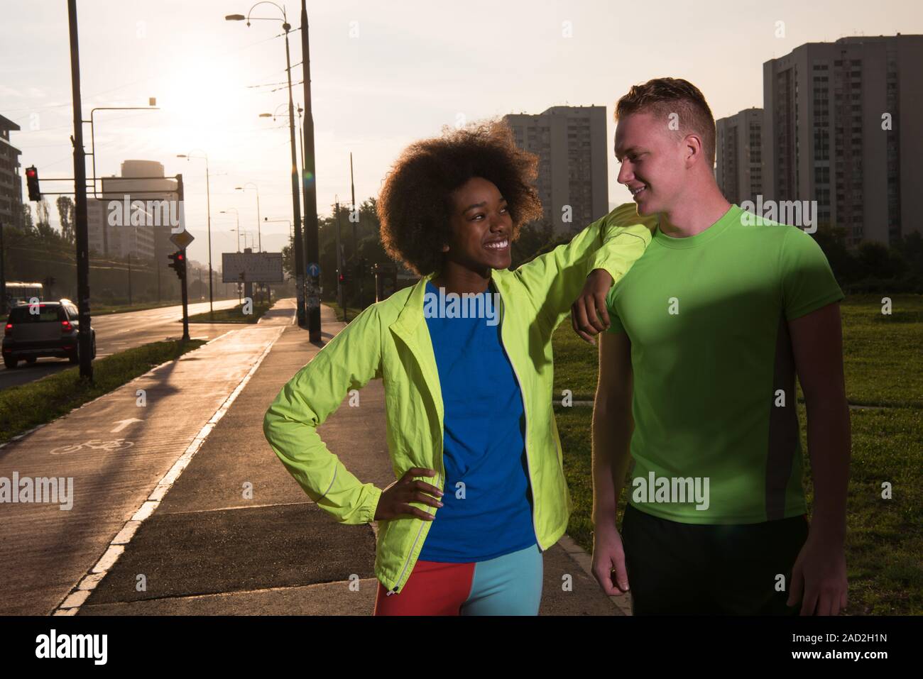 Portrait of romantic pretty couple on fitness session, outside town ...