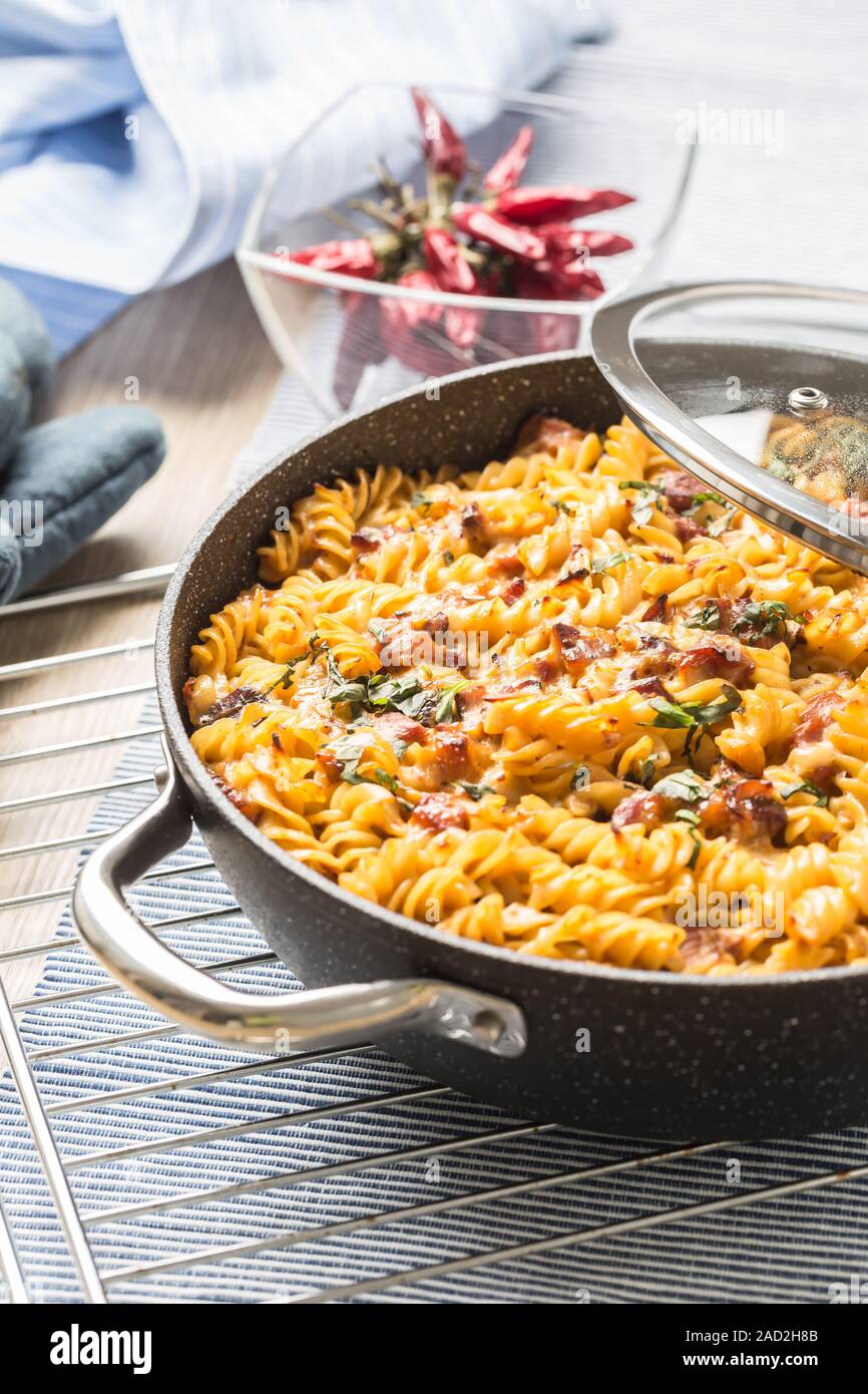 Baked pasta fusilli with smoked pork neck mozzarela cheese and othe ...
