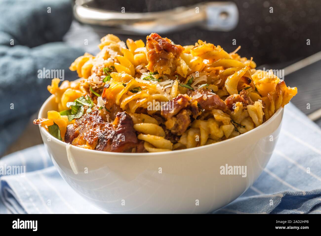 Baked pasta fusilli with smoked pork neck mozzarela cheese and othe ...