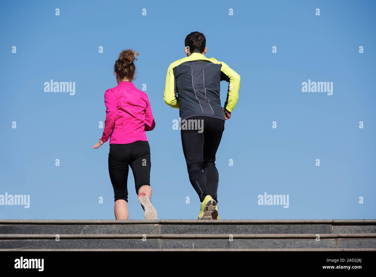 young couple jogging on steps Stock Photo - Alamy