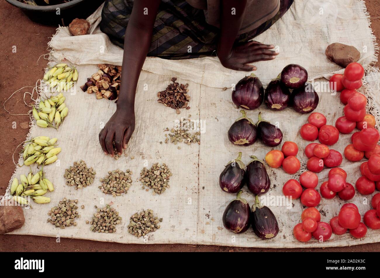 Vegetable stall. Trader selling a variety of vegetables, including okra ...