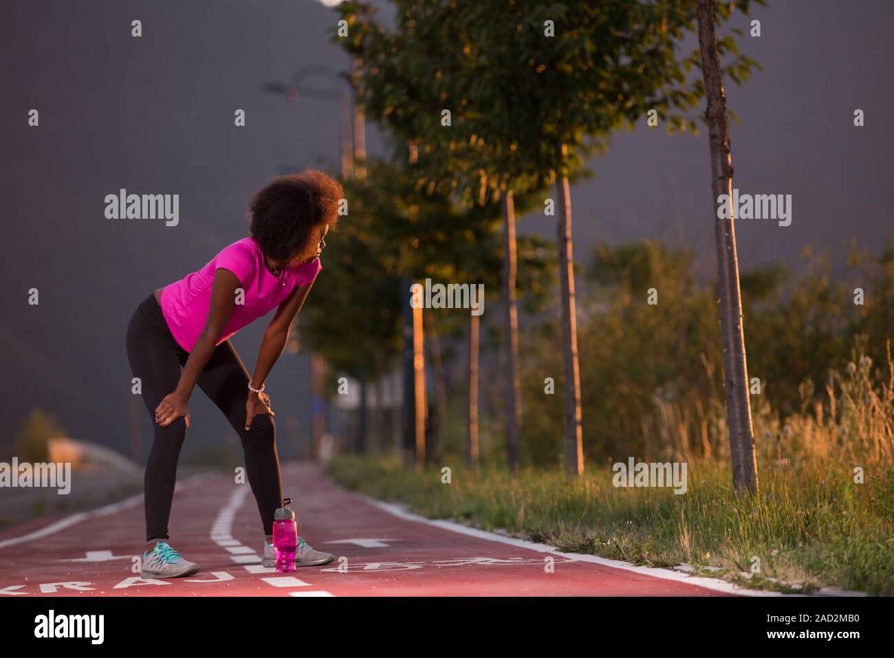 Portrait of a young african american woman running outdoors Stock Photo ...