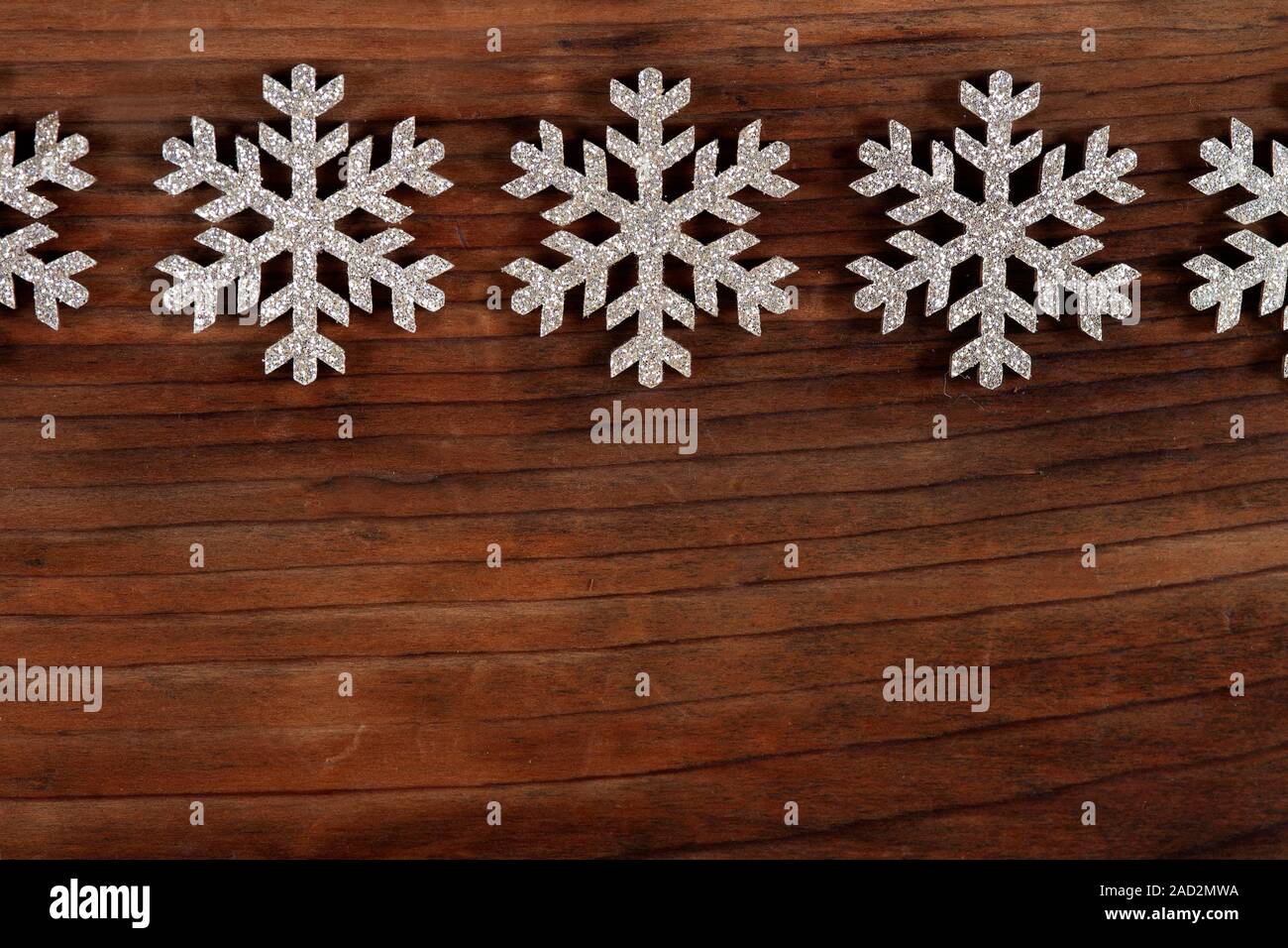 Snowflakes on wooden background with copy space. Top view and flat lay ...