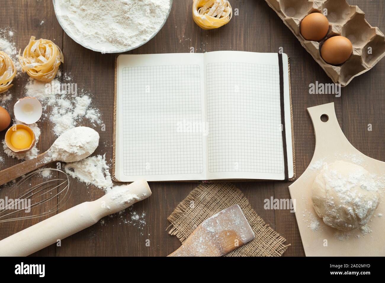 Cooking some tasty food and writing down recipe In open clear note ...