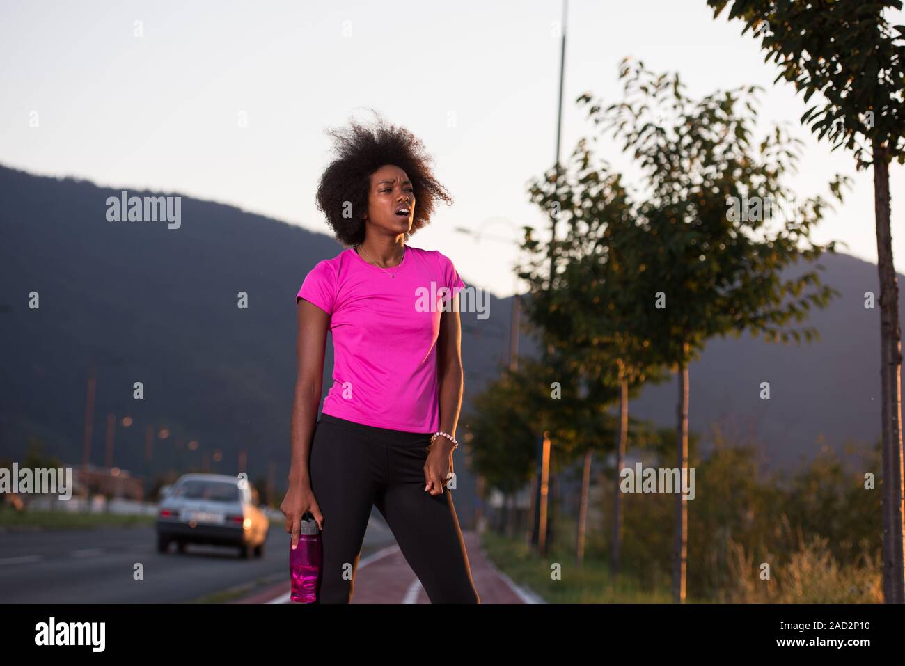 Portrait of a young african american woman running outdoors Stock Photo ...