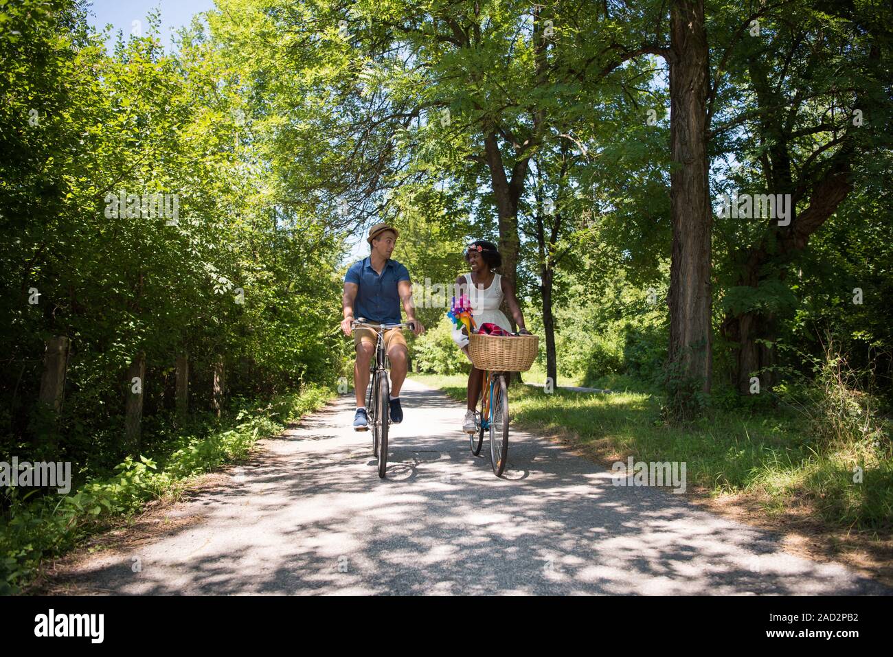 Young multiethnic couple having a bike ride in nature Stock Photo - Alamy