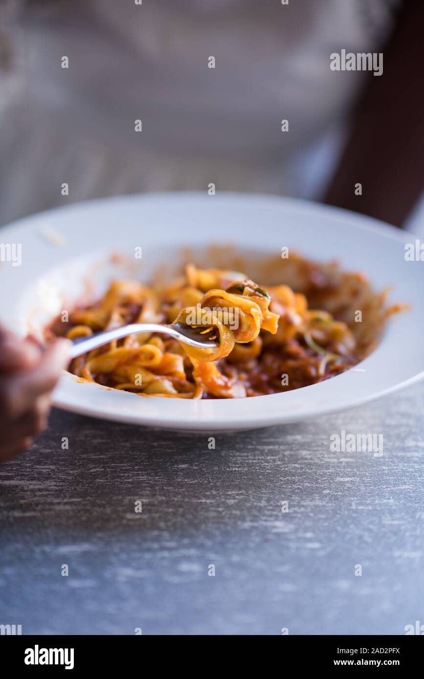a young African American woman eating pasta Stock Photo - Alamy